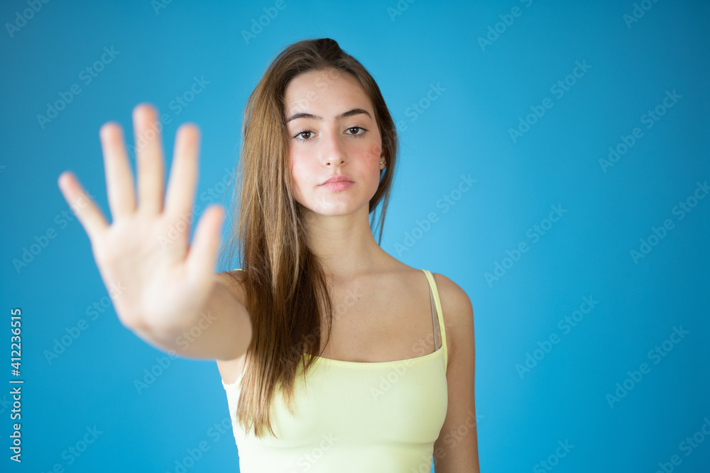 Portrait of a serious young girl standing with outstretched hand ...