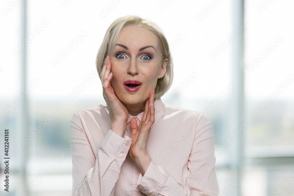 Happy and surprised mature businesswoman. Astonished american caucasian ...