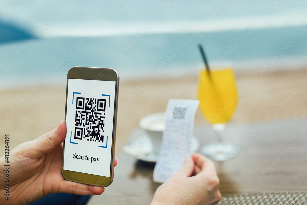 Women's hands are using the phone to scan the qr code to pay juice and ...