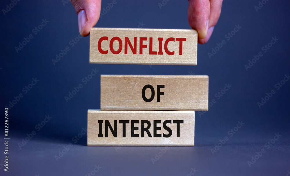 Conflict of interest symbol. Businessman hand. Wooden blocks with words ...
