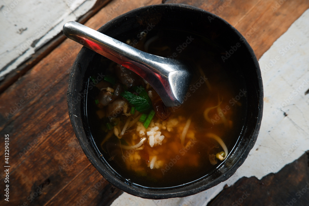 Soto batok. Batok soup is a soup served in a coconut shell bowl ...