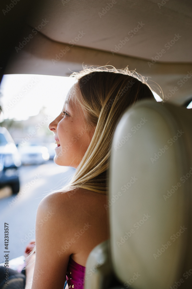 Young girl sitting in back of car with profile at golden hour Stock ...