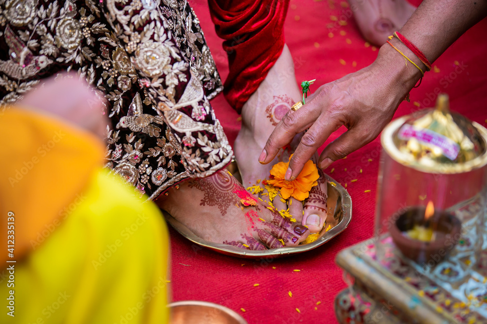 Indian Hindu couple's feet close up, wedding ceremony, religious items ...