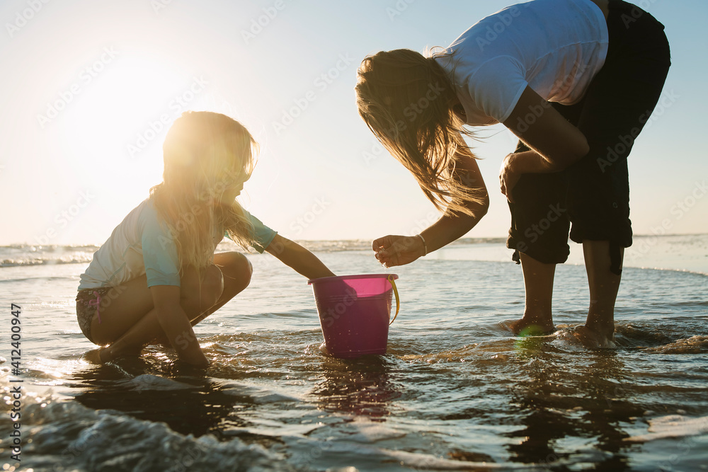 Child Collecting Shells at the Beach with Mother and Family Stock Photo ...