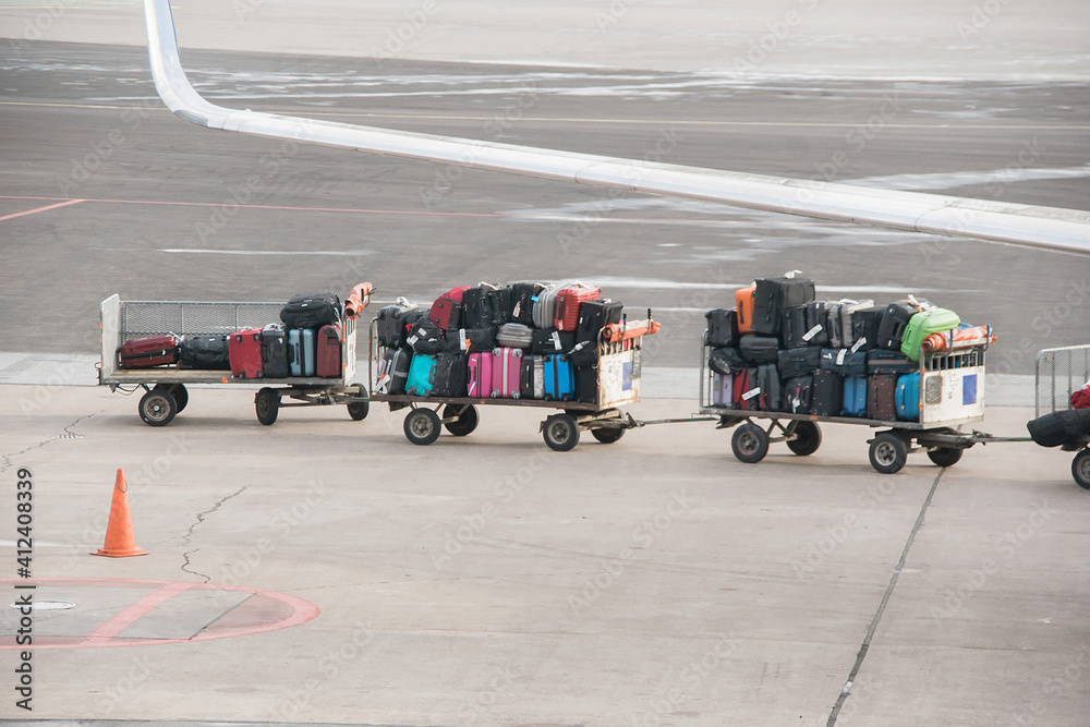Offloading of luggage from aircraft Stock Photo | Adobe Stock