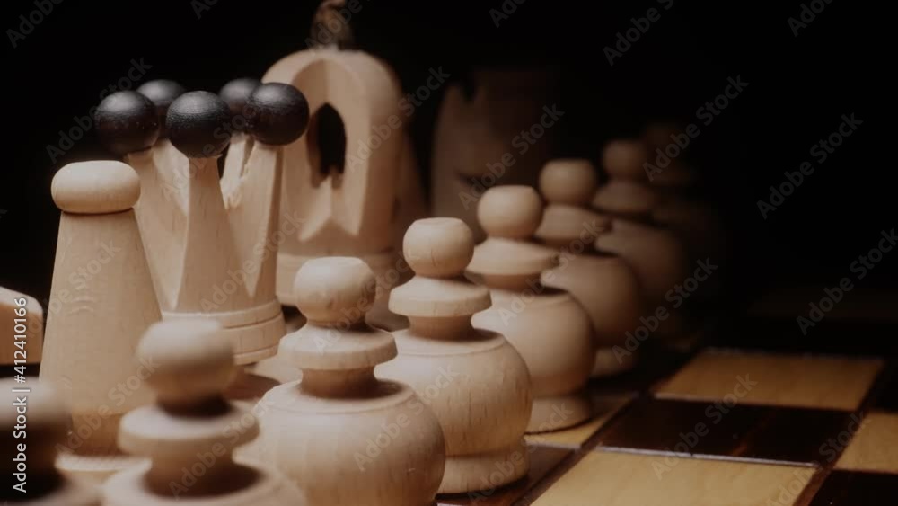 Chess pieces ready for a game. Light flashing over a chess board ...