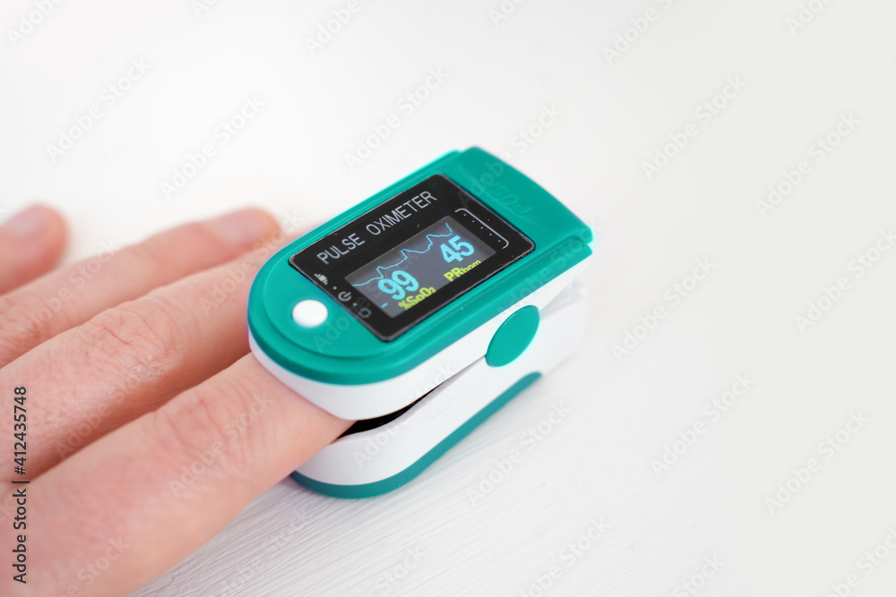 Pulse oximeter used to measure pulse rate and oxygen levels with hand ...