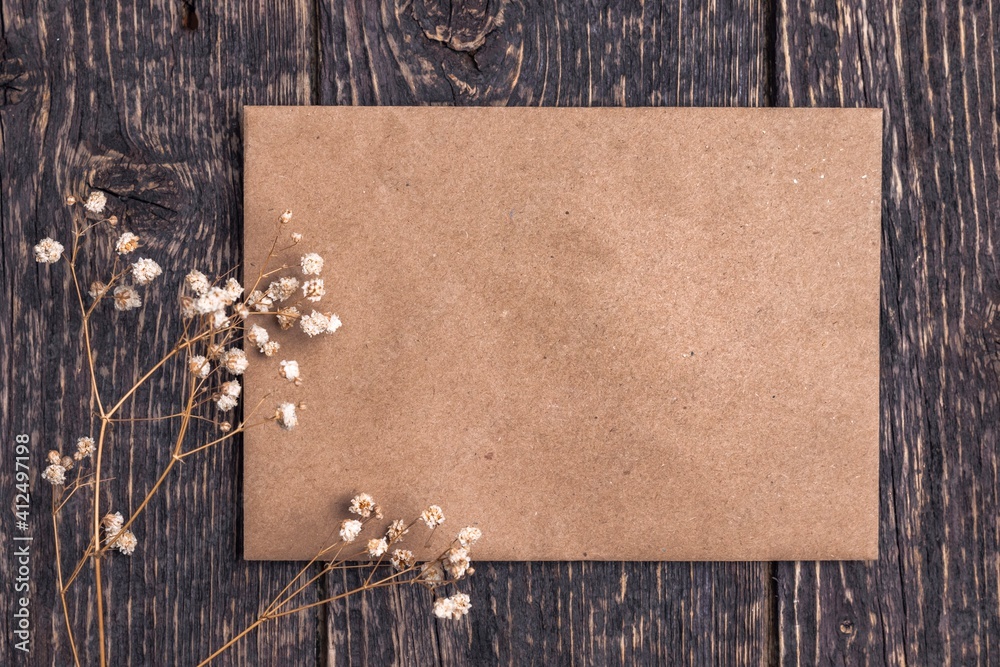 Rectangular template envelope from old paper and a sprig of dried ...