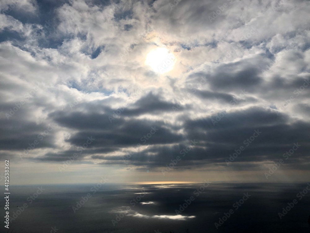 Foto de Sol brillante en el cielo lleno de nubes blancas con los rayos ...