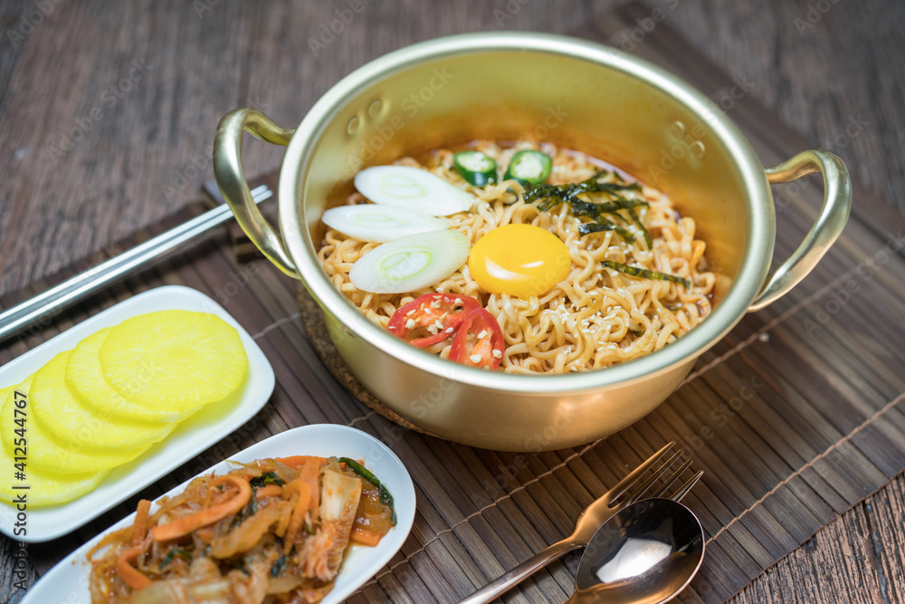 Korean traditional Ramyeon noodle with egg yolk, chilli, kimchi in a ...