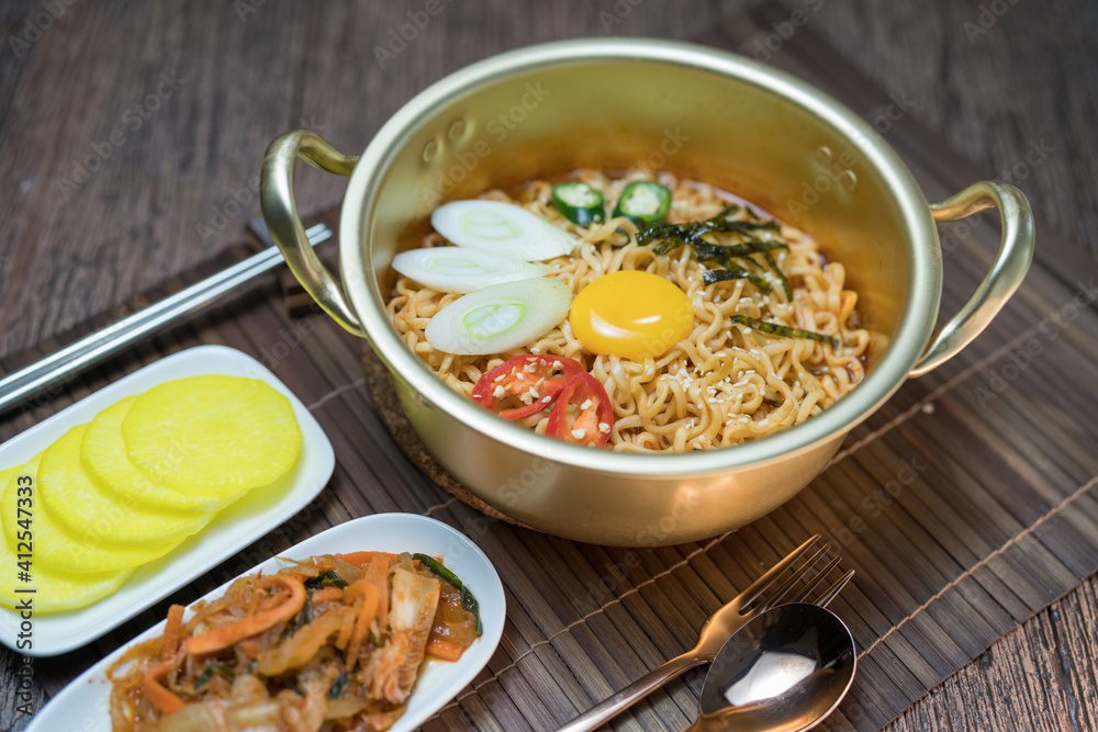 Korean style instant noodle, Ramyeon with egg yolk, chilli, kimchi ...