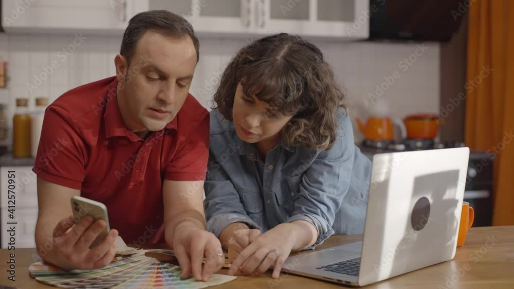 Young couple choosing colors from the color guide palette.The newly ...