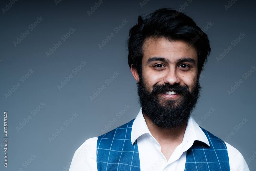 Handsome hindu man in white shirt with black beard smiling at camera ...