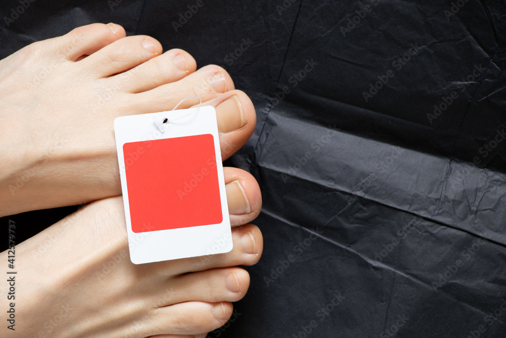 womens bare feet with white blank tag, price tag on legs Stock Photo ...