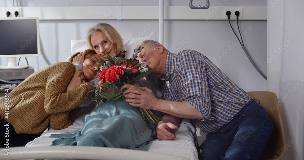 Happy senior husband and young daughter visiting and cheering woman ...