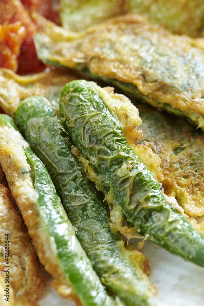 Vertical shot of deep fried green chili peppers Stock Photo | Adobe Stock