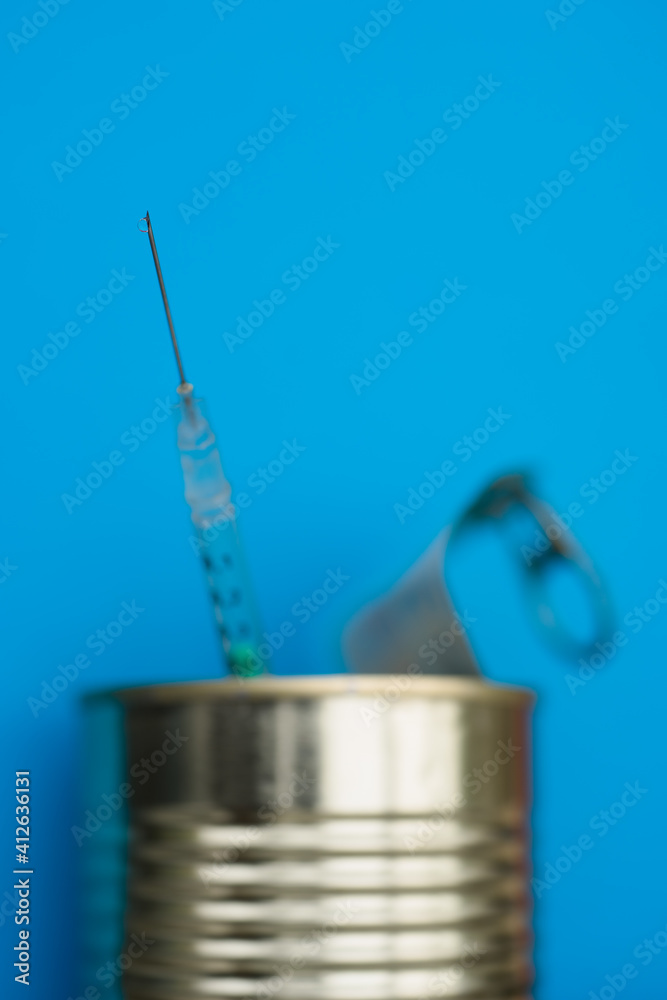 Vaccination kit made of a tin can with syringe with cannula and a drop ...