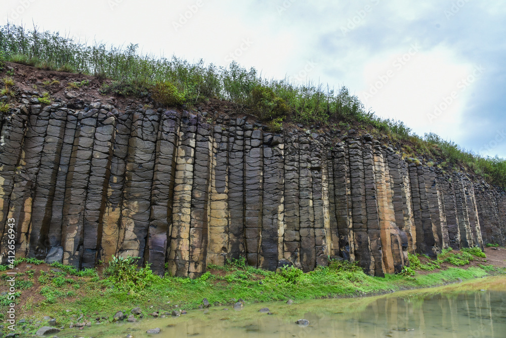 Terracotta columnar basalt columns on the tropical island of Penghu ...
