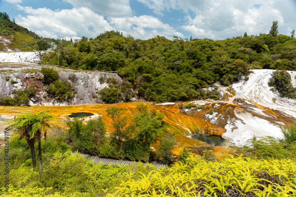 A photo of geothermal area with hot water flowing down from the hot ...