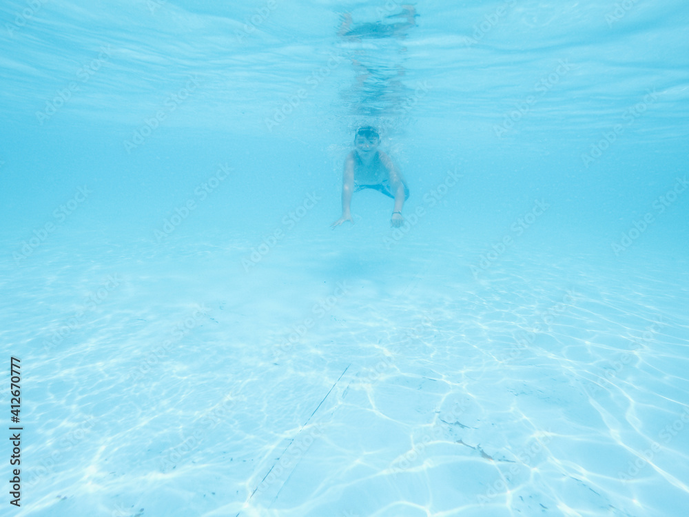 boy swimming in pool with blue water in vacation Stock Photo | Adobe Stock