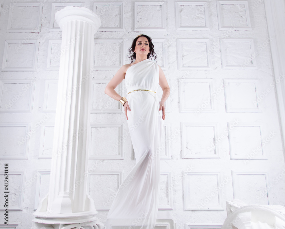 Beautiful Greek goddess woman close up among the white ancient ruins ...