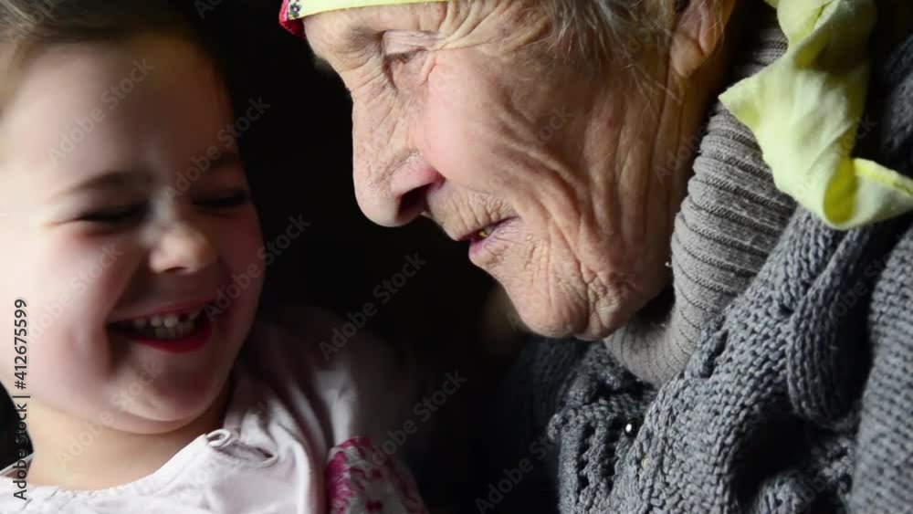 Happy grandmother in an embrace with a child. Mothers Day. Happy child ...