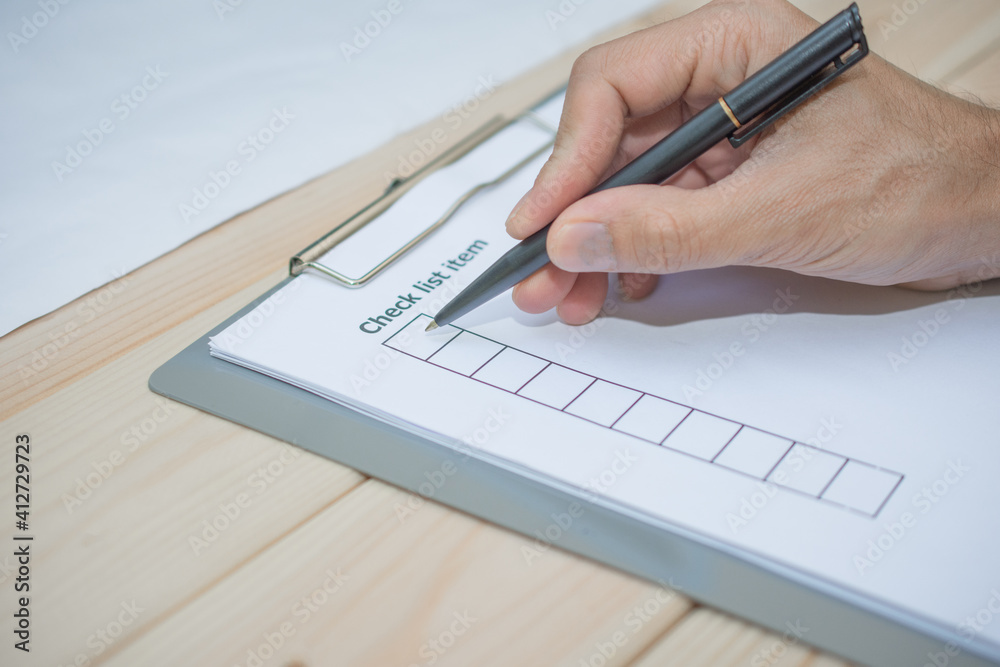 Hand checking on document check list item Stock Photo | Adobe Stock