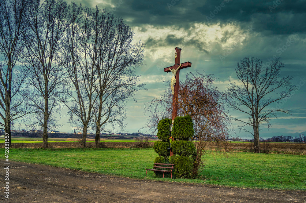 Roadside cross in the countryside on a gloomy day, characteristic of ...