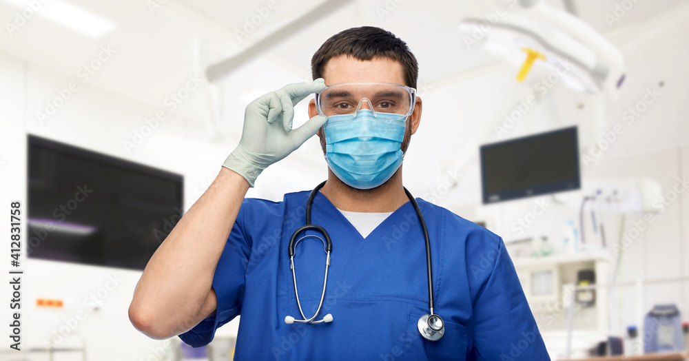 medicine, healthcare and surgery concept - doctor or male nurse in blue ...