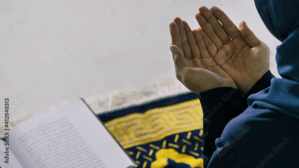 Muslim young woman in hijab is praying glorify Allah and practicing the ...
