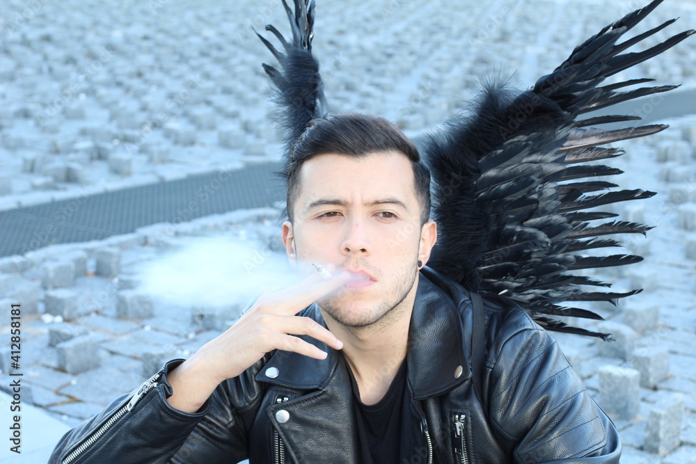 Attractive angel smoking a cigarette Stock Photo | Adobe Stock