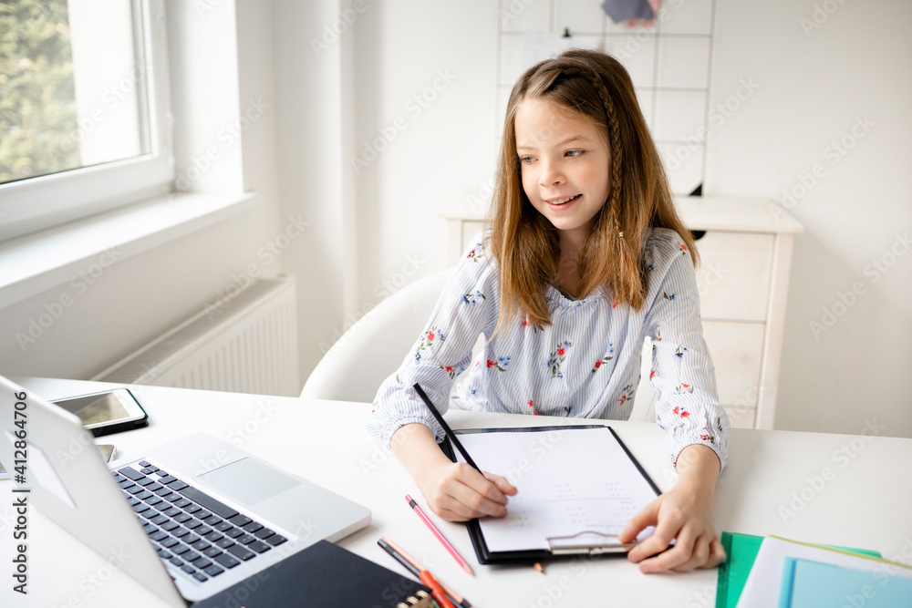 girl school pupil distance learning doining school homework, watching ...