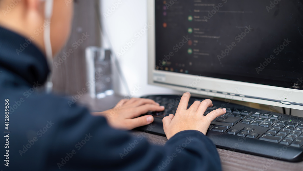 Boy using PC at home Stock Photo | Adobe Stock