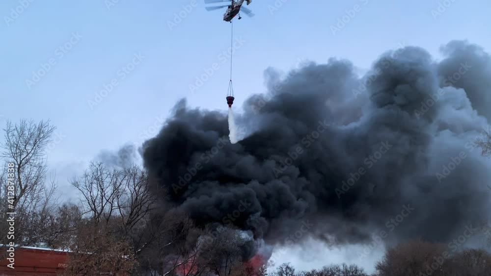 Firefighting helicopter water drops. Aerial firefighting technology in ...