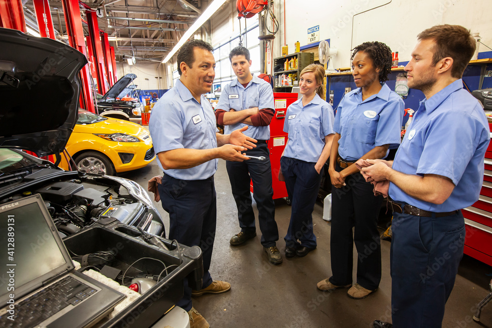 Men and women of diverse ethnic backgrounds, a team of mechanics in an ...