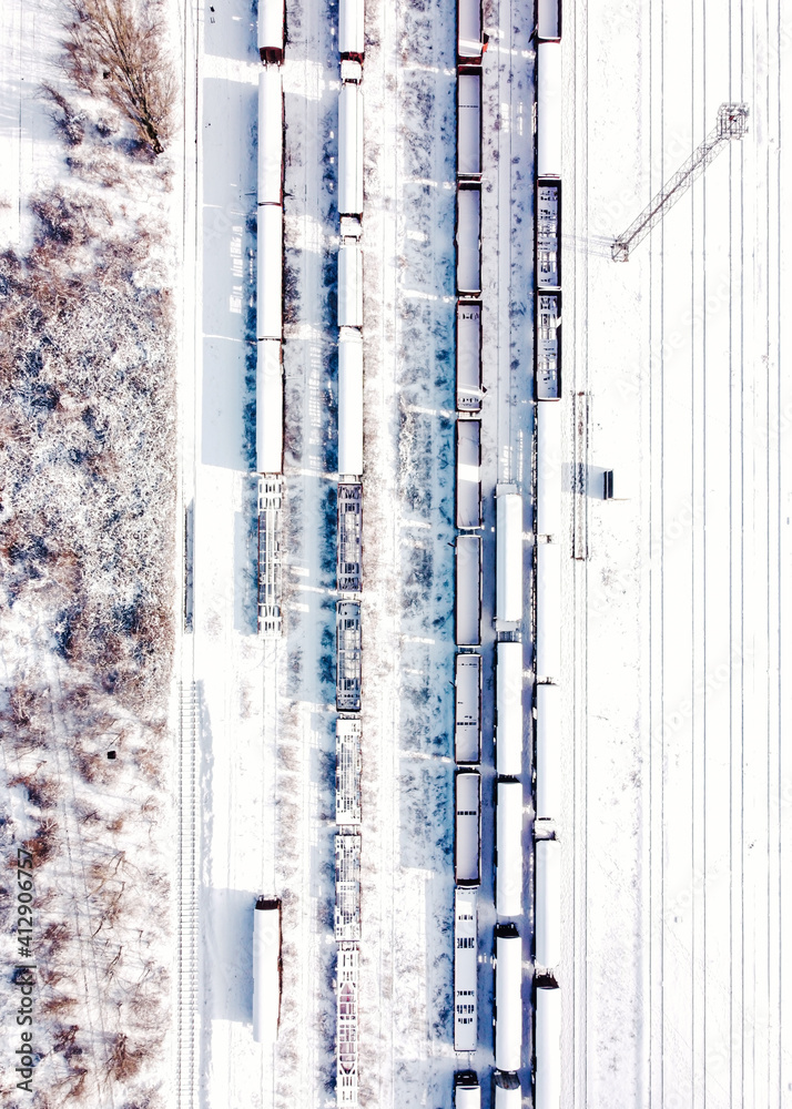 Top view of cargo trains. Aerial view from flying drone of snow covered ...