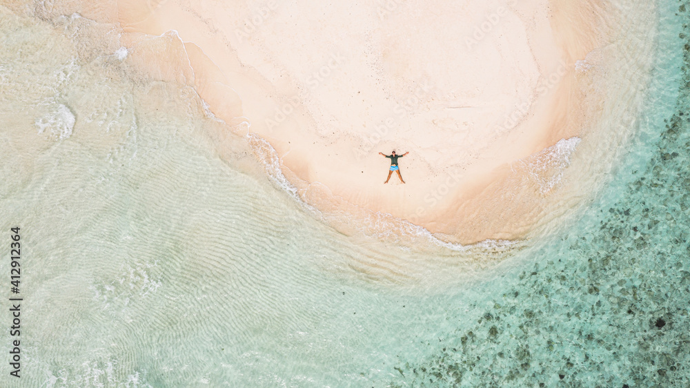 Aerial View Of Man Lying On Sandy Beach Near Turquoise Sea In Kri ...