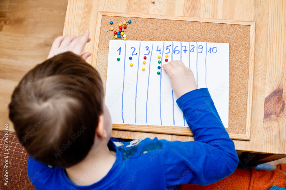 Little child doing simple math exercises. Early education, counting ... Little child doing simple math exercises. Early education, counting ...