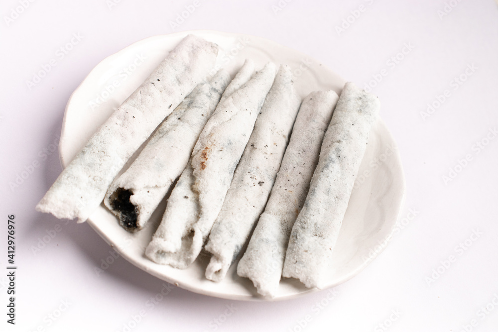 Til pitha a traditional food of Assam isolated stock image. Stock Photo ...