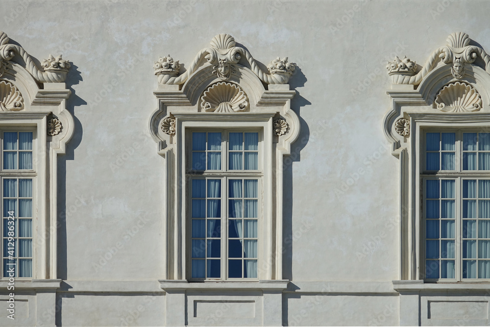 Detail of a stone window with sculptures baroque, on the facade of the ...