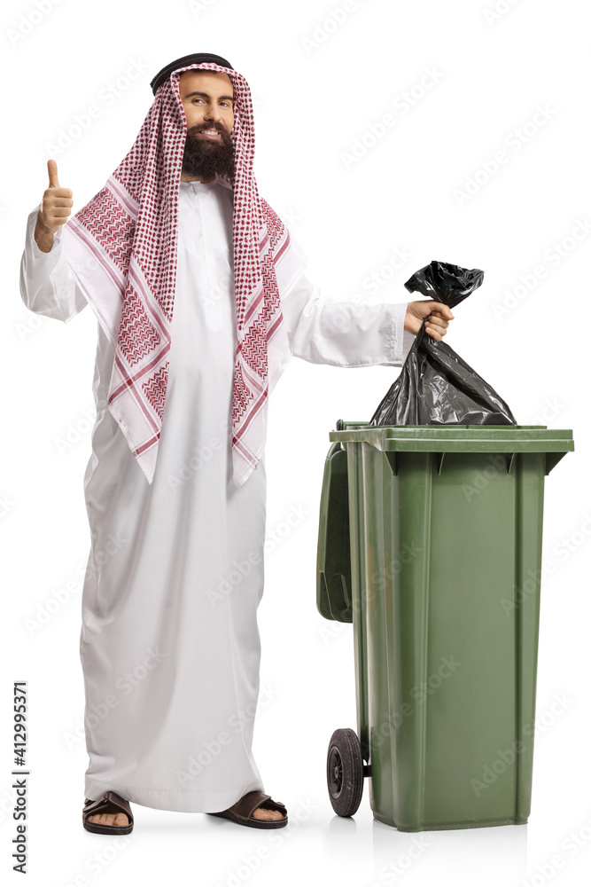 Full length portrait of a saudi arab man throwing a plastic bag in a ...