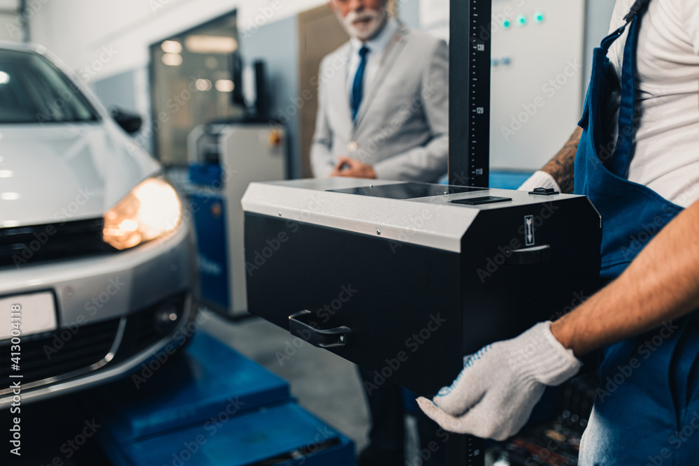 Car mechanic and senior business man costumer during periodic car ...