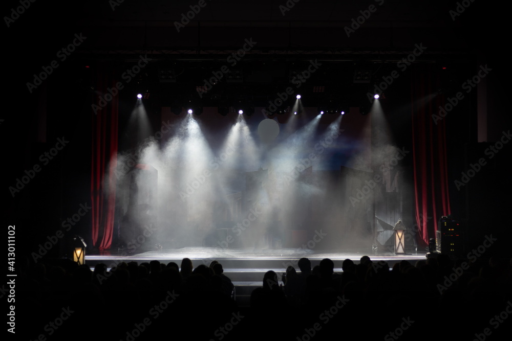 An empty stage of the theater, lit by spotlights and smoke before the ...