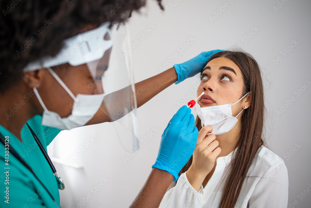 Close-up of a woman having PCR test at medical clinic. Close-up of ...