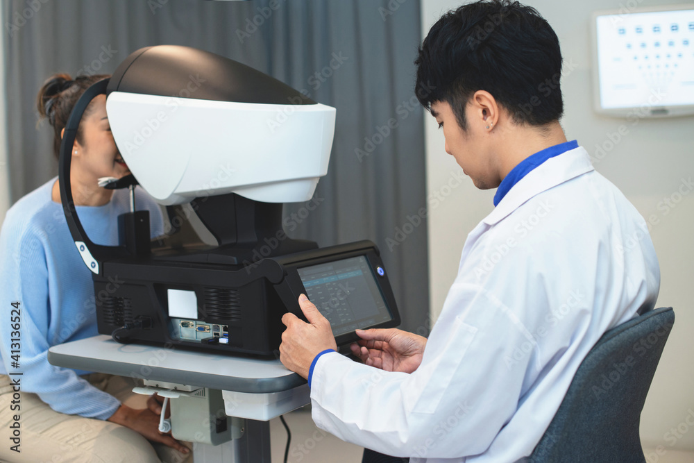 Asian senior woman with eye vision measurement machine in clinic ...