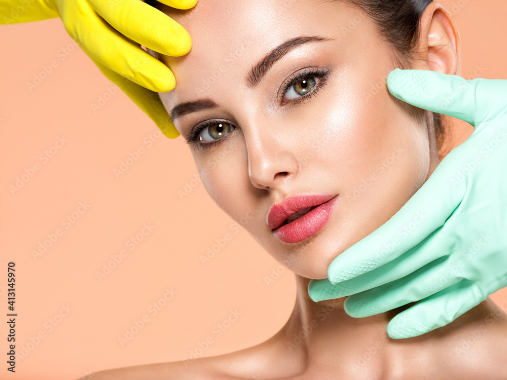 Face skin check before plastic surgery. Beautician touching young woman ...