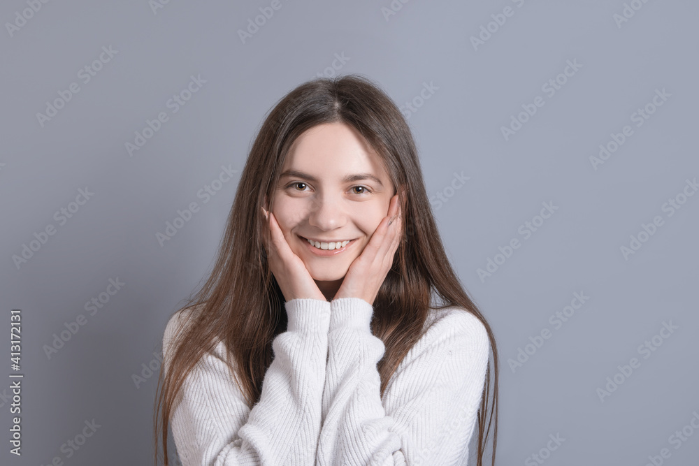 Pretty smiling joyfully female with dark hair, dressed casually ...