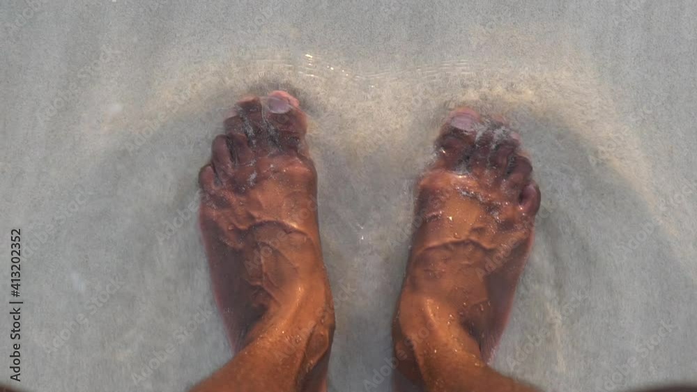 Close up view of an adult black male looking at his feet while standing ...