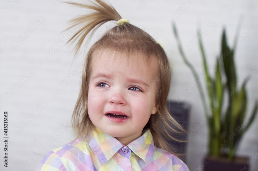 Sad little girl toddler crying. Lonely and unhappy baby girl with funny ...