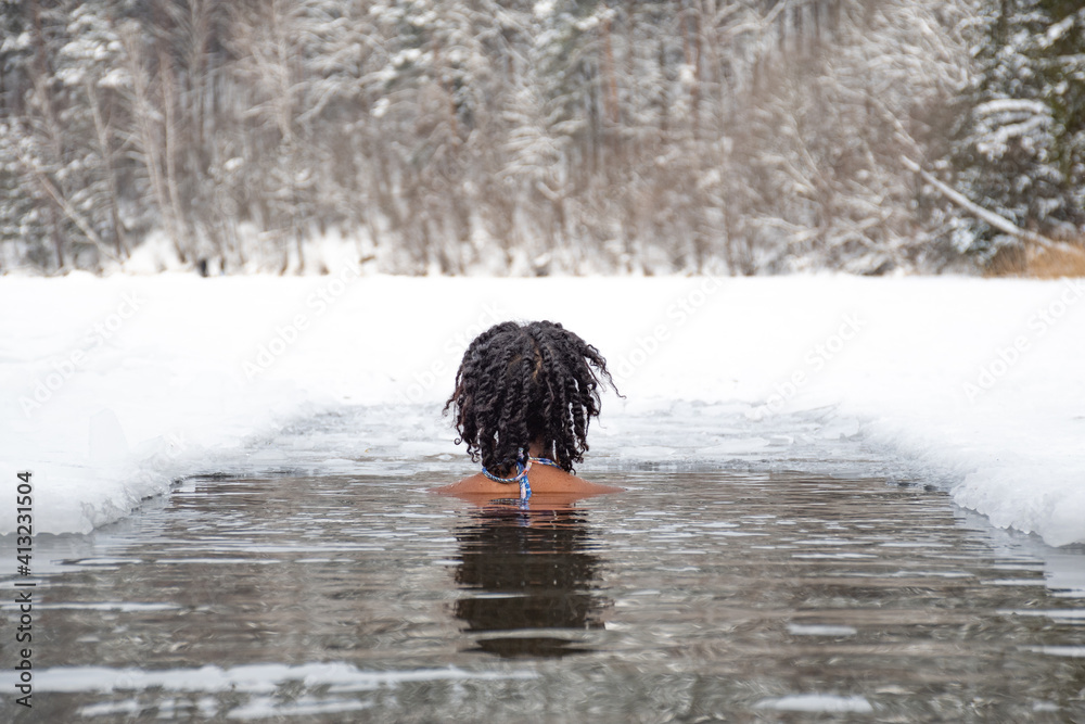 Beautiful girl swimming in the cold water of a lake or river, cold ...